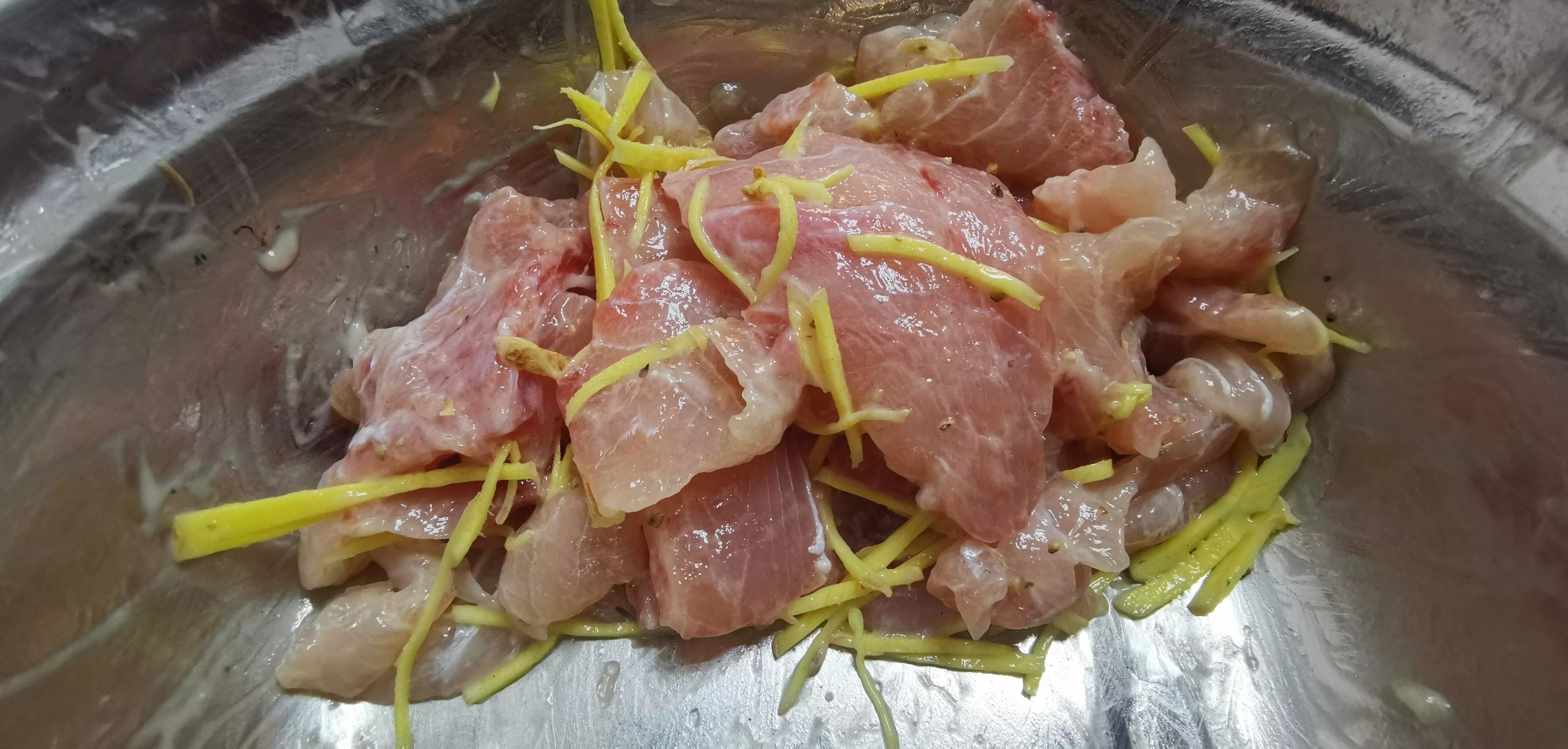 The rare wild big golden pomfret, the meat is pink, cut into a small ...