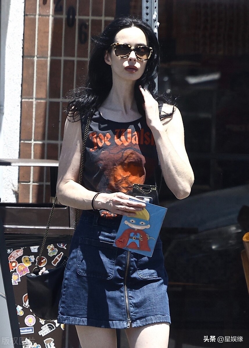 Christen Ritter is chic and handsome in a black portrait print vest ...