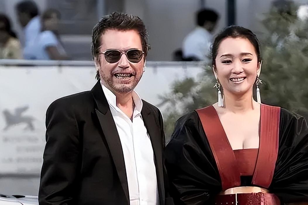 Gong Li and her husband walked the red carpet in Cannes, dressed in a ...