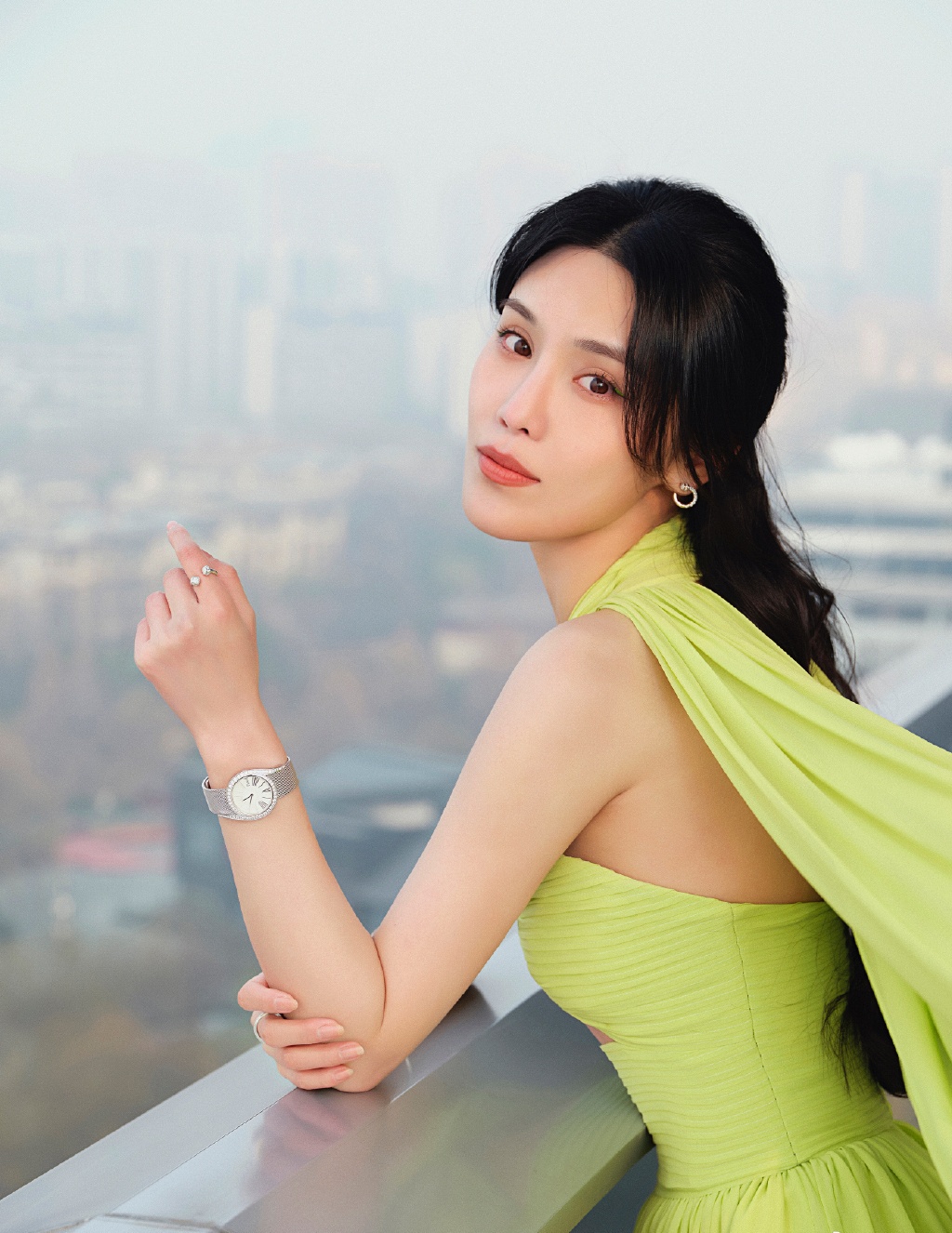 Actress Han Dantong wears a long green flowing dress with shawls ...