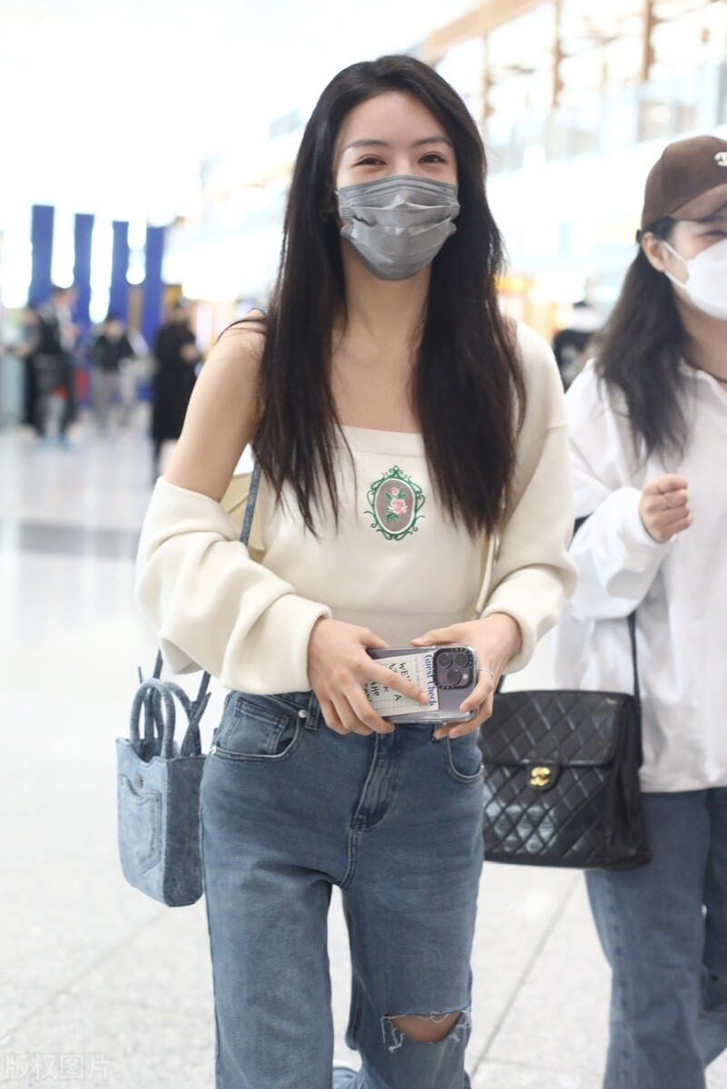 Cai Wenjing waved to fans at the airport wearing a tube top and jacket ...