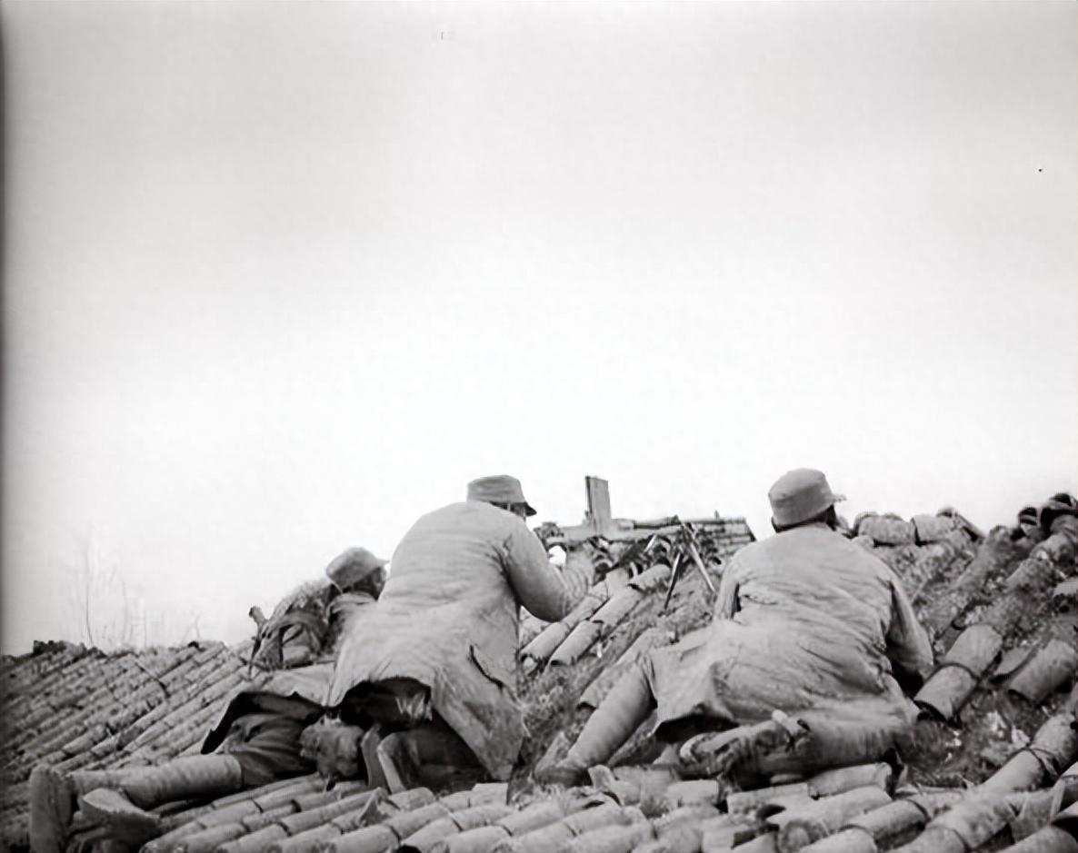A PLA demolition man carries explosives on his back, holds the landing ...