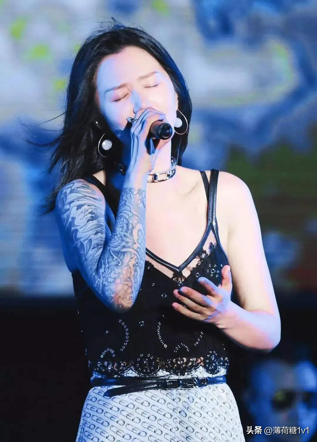 With tattooed arms and eight-pack abs, female rock singer Tan Weiwei is ...