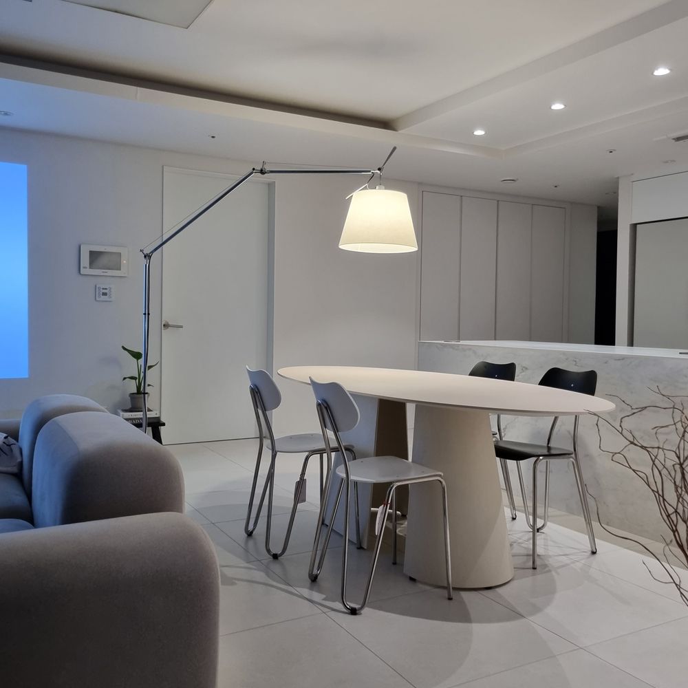 Clean and minimalist gray and white, open-plan dining and kitchen space ...