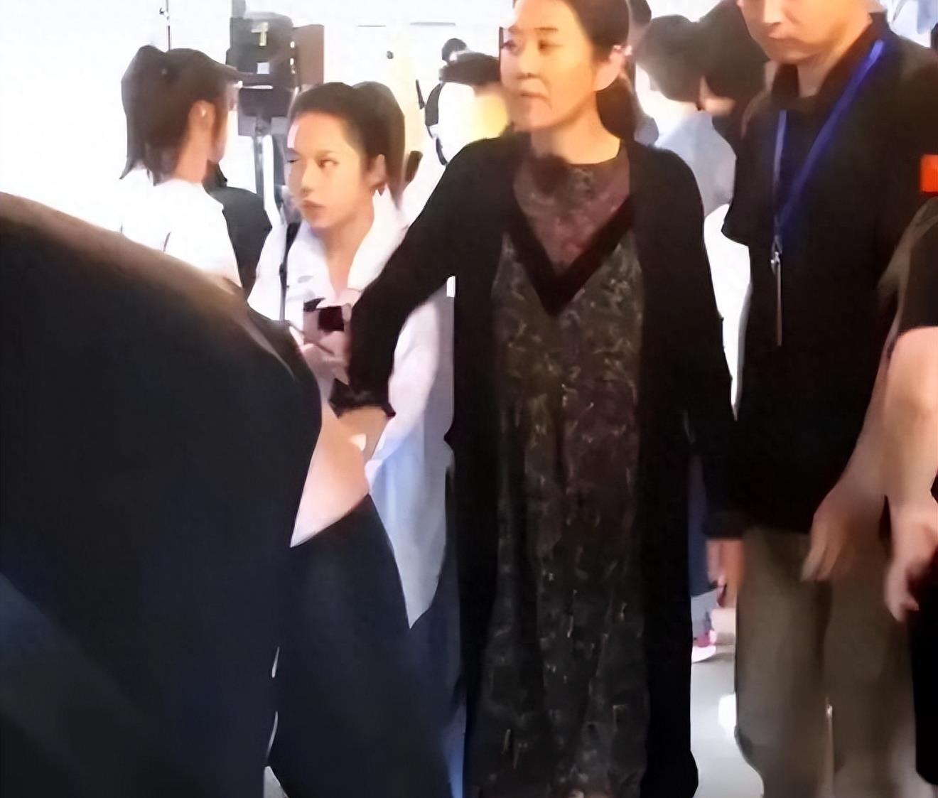 Ni Ping was photographed on the street. She is thin and hunched. She ...