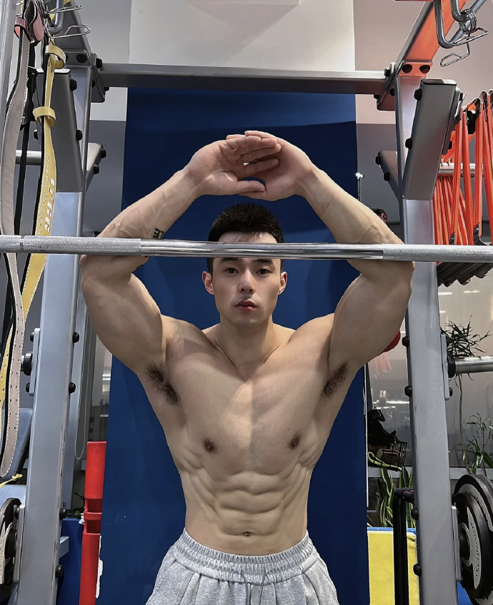 A man with thick arms, thick pectoral muscles, short inches, tall nose ...