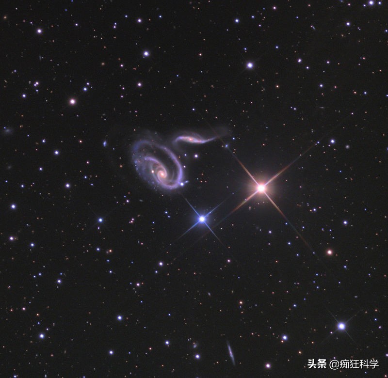 Small galaxy steals material from large galaxy NGC 169, scientists ...