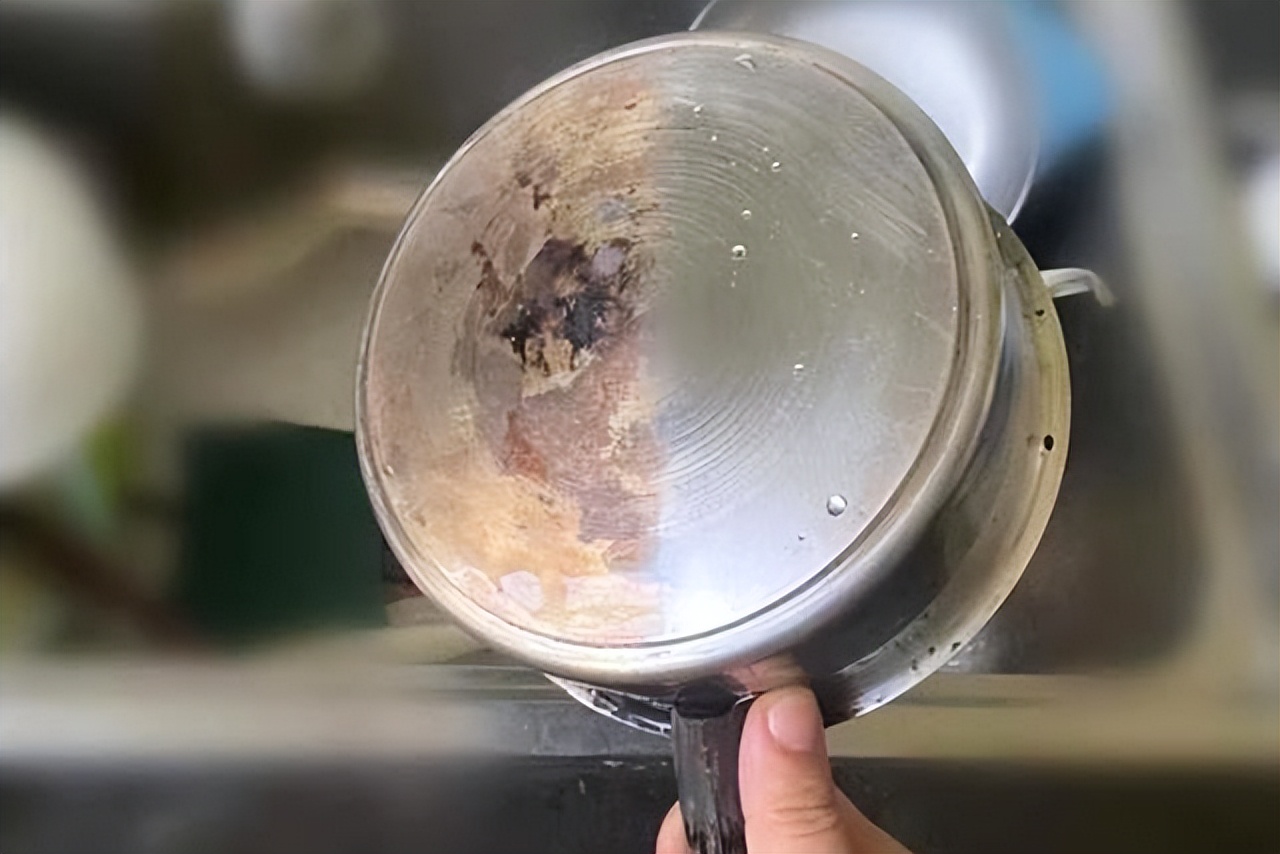 The burnt and blackened stainless steel pot is difficult to remove. Don ...