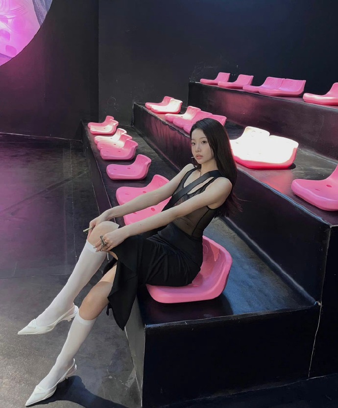 Fashionable street shot of a beautiful woman in a see-through vest and ...