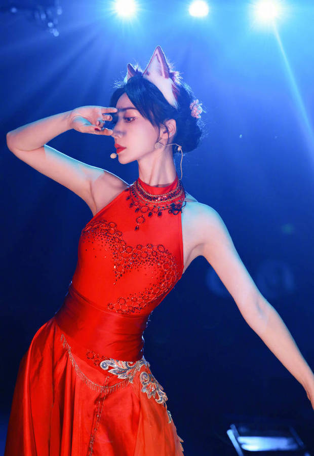 Liu Yan, dressed in red and wearing nine-tailed fox make-up, is ...