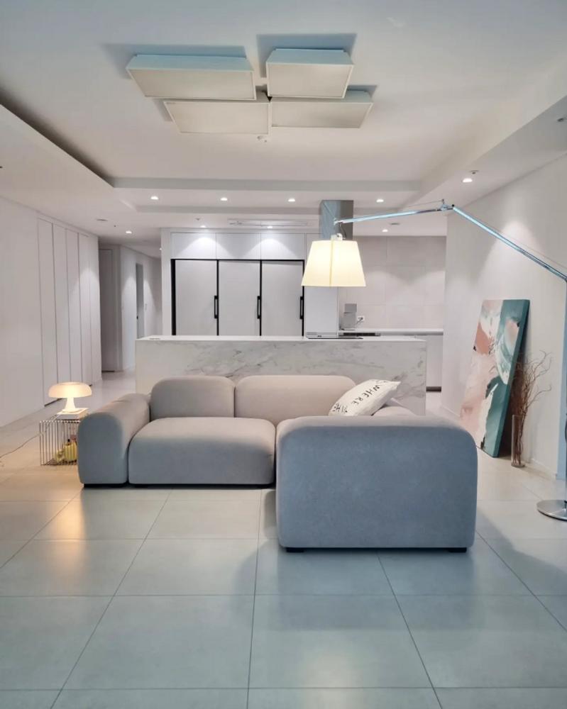 Clean and minimalist gray and white, open-plan dining and kitchen space ...