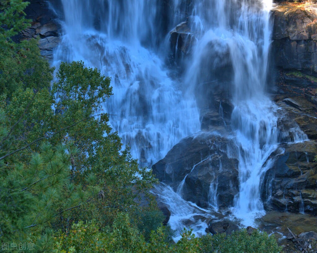 The thousand-foot Pearl Falls are surrounded by steep cliffs with ...