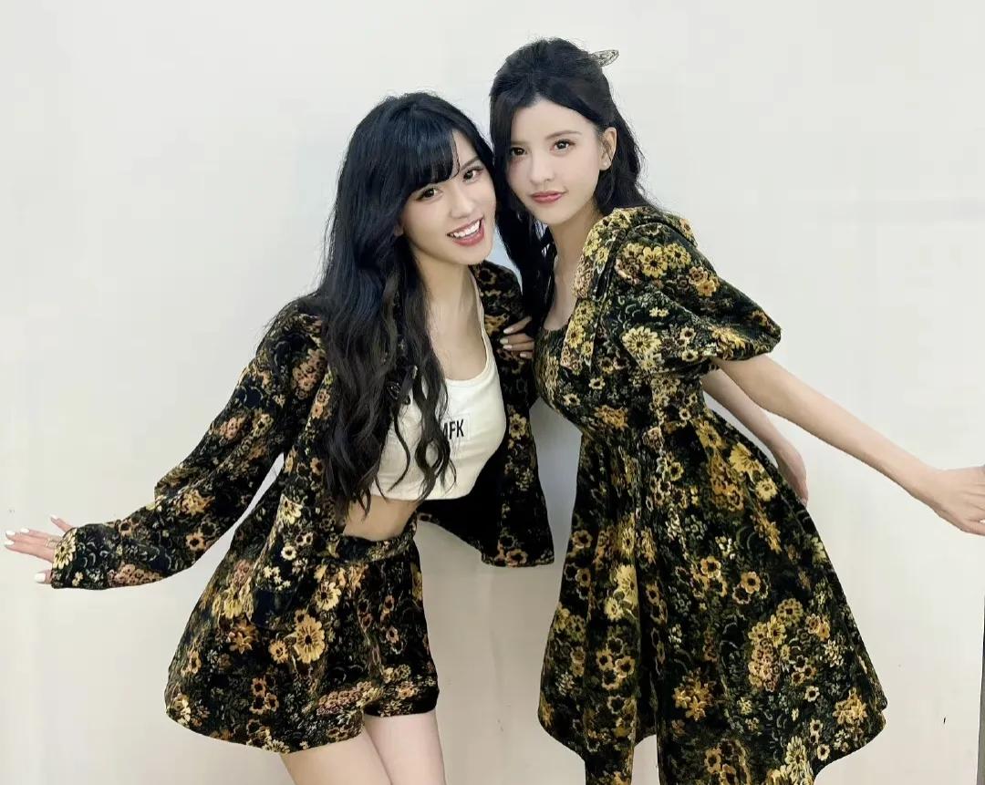 By2 singing group two sisters in a long skirt with broken leaves, enjoy ...