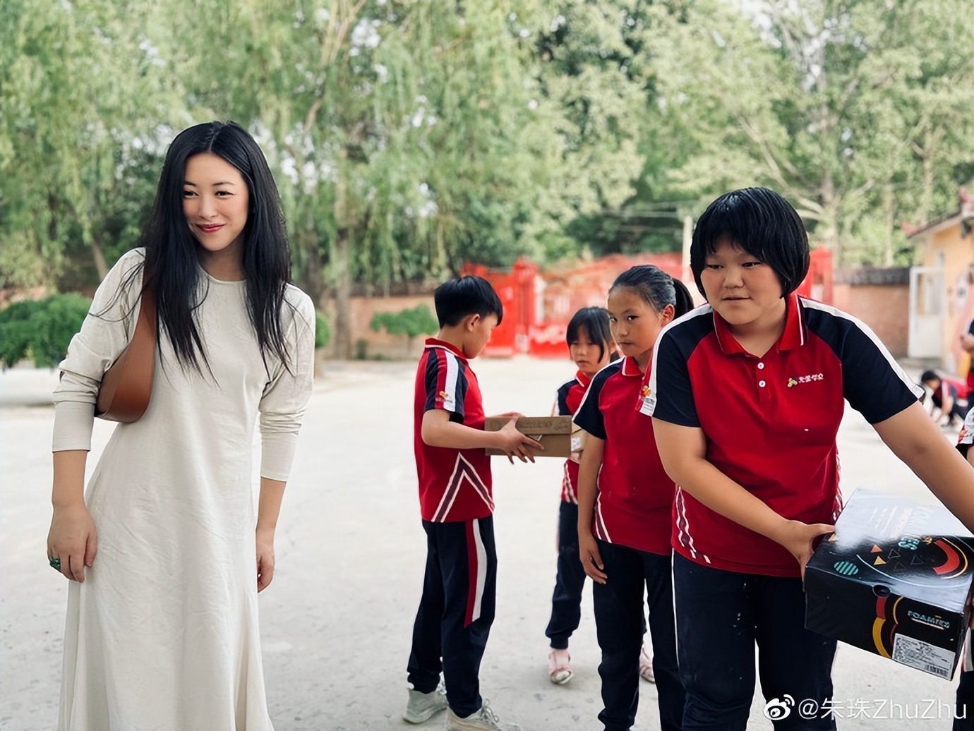 Zhu Zhu's family of three donated shoes to the students. The children ...