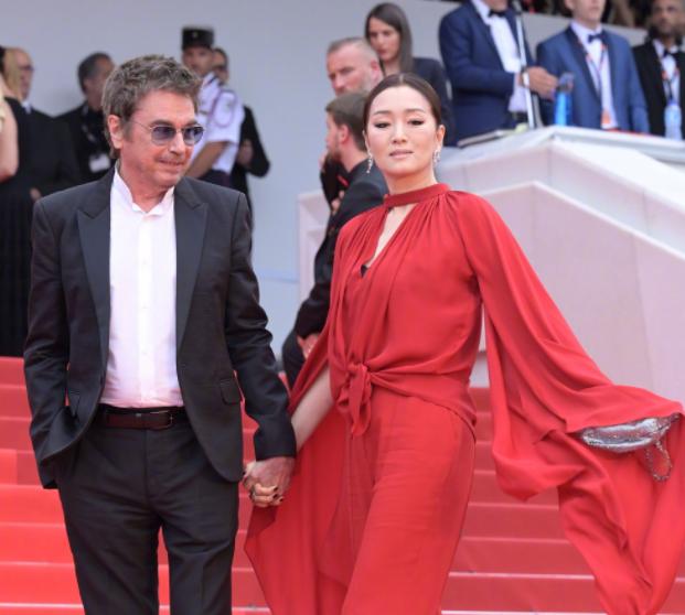Gong Li and her husband walked the red carpet in Cannes, dressed in a ...
