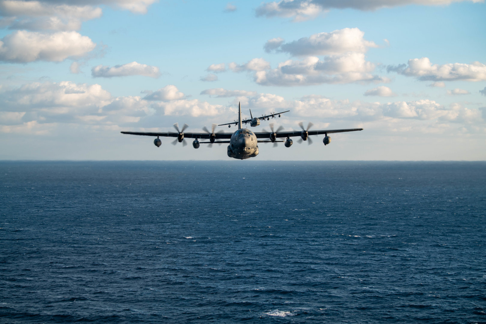 Two MC-130J Special Forces II aircraft fly in formation during the gull ...