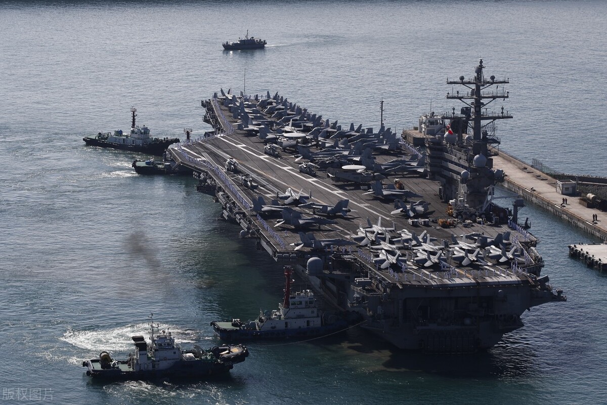 The amphibious assault ship USS America docks in Osaka, indicating that ...